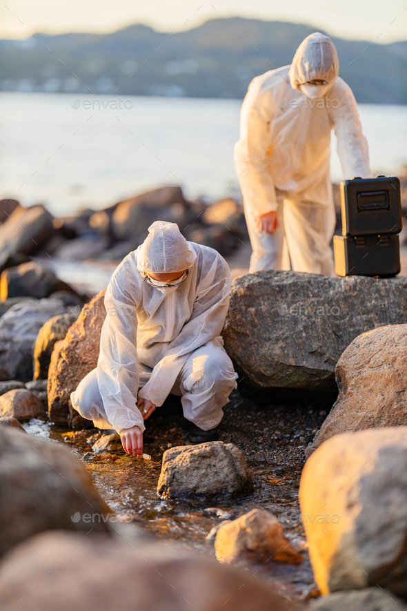 Scientist collecting water sample at the seashore Stock Photo by kjekol
