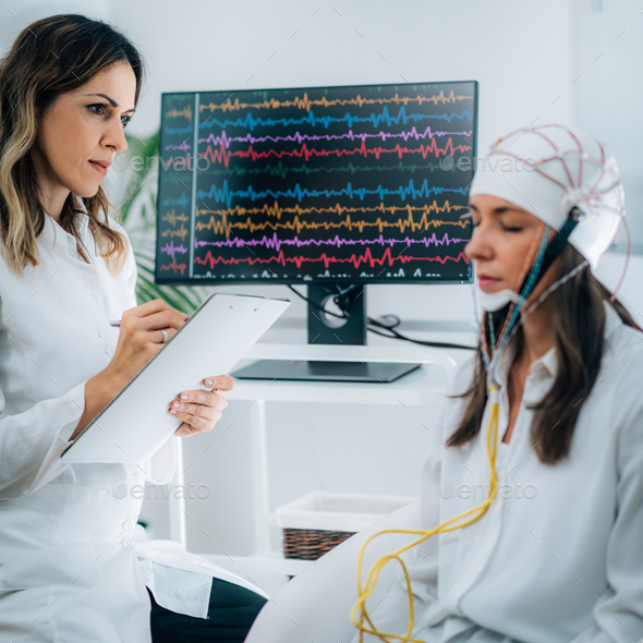 Female Patient in a Neurology Lab doing EEG Scan Stock Photo by microgen