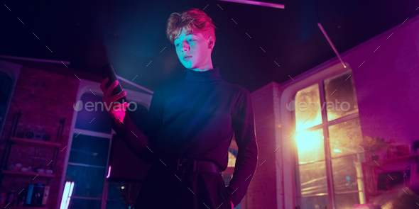 Cinematic portrait of handsome young man in neon lighted interior Stock ...