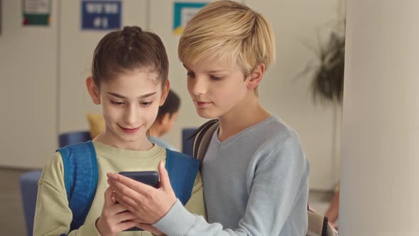 School Children Scrolling on Smartphone during Break, Stock Footage