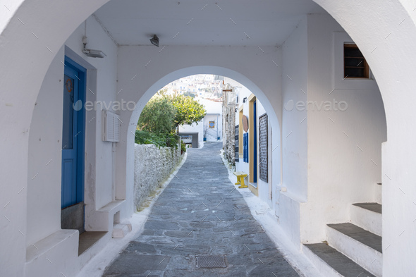 Traditional greek whitewashed buildings, cobblestone streets and stone ...
