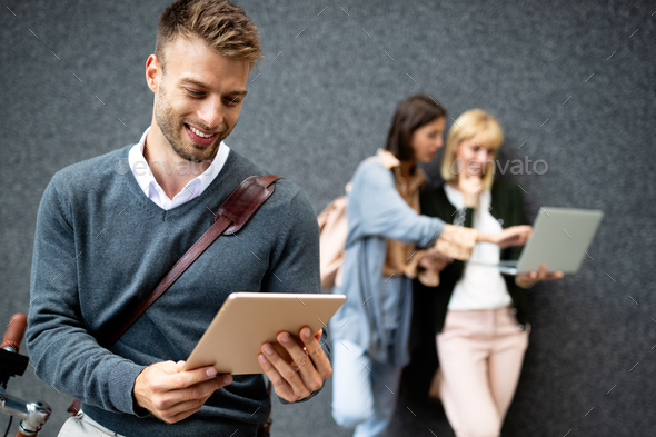 Group of business people using electronic devices outdoor Stock Photo ...