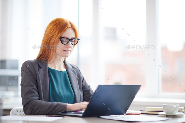 Modern Female Boss Using Laptop Stock Photo by seventyfourimages ...