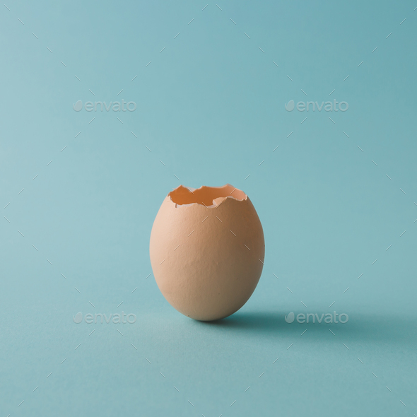 Egg shell on bright blue background. Minimal concept. Stock Photo by ...