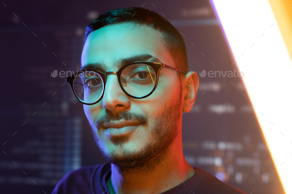 Face of young clever confident programmer or software developer in ...