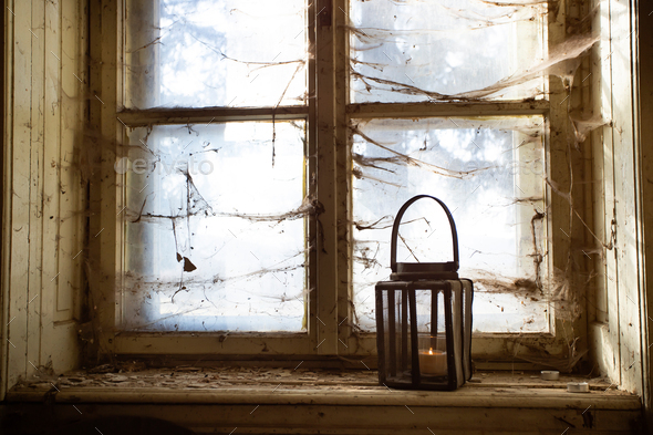 Spooky window with lantern and spider web. Stock Photo by erika8213
