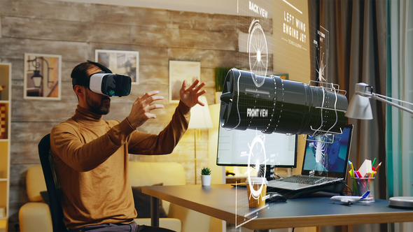 Engineer with VR Headset Working in Virtual Enviroment To Design a New ...