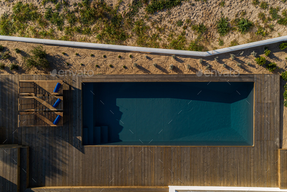 Aerial view of modern villa with pool and deck Stock Photo by luisviegas