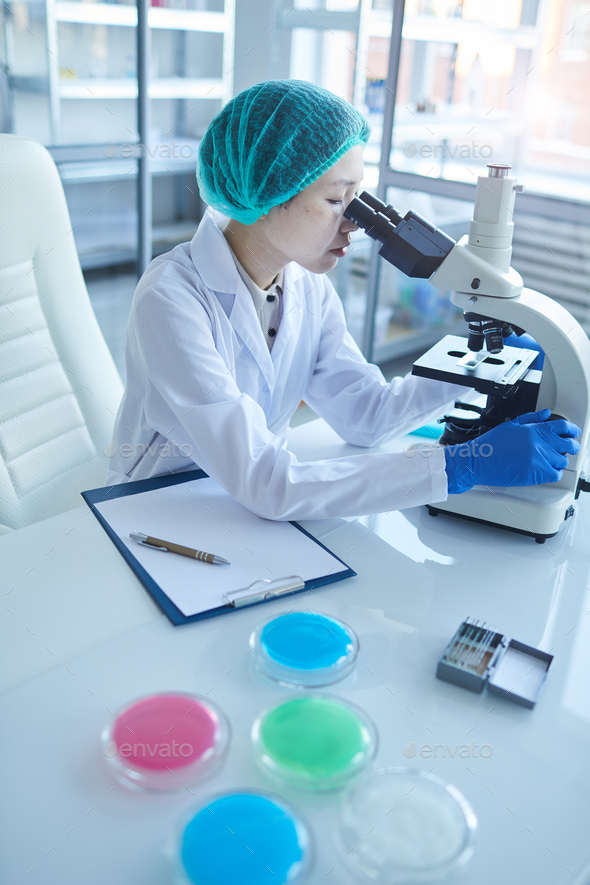 Female Asian Scientist Using Microscope Stock Photo by AnnaStills ...