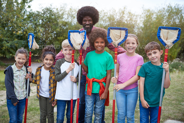 Portrait Of Team Leader And Group Of Children On Outdoor Activity Camp ...