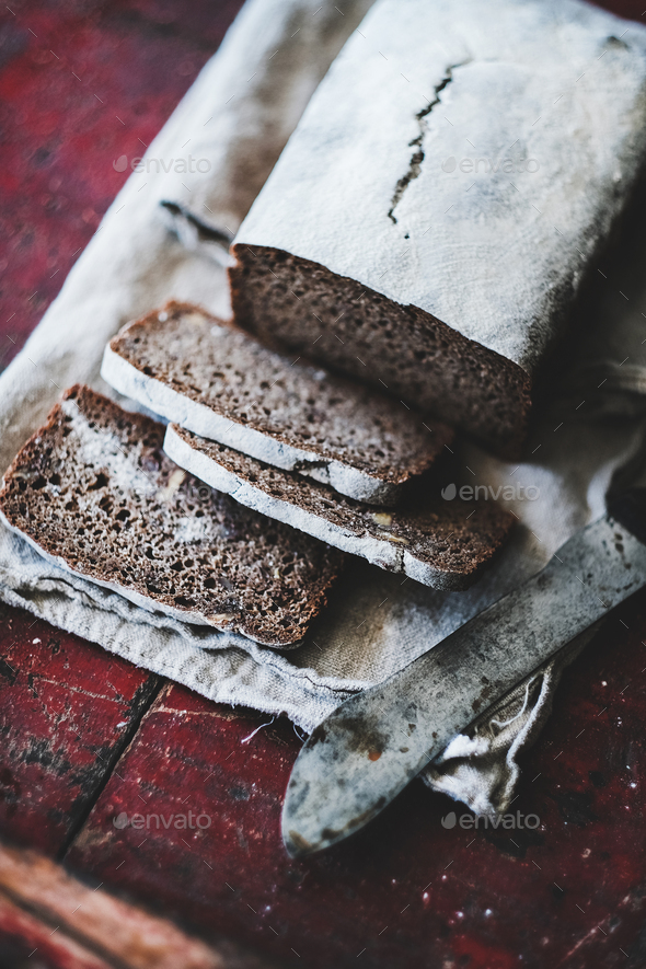 Rye Swedish bread loaf cut in slices with vintage knife Stock Photo by ...