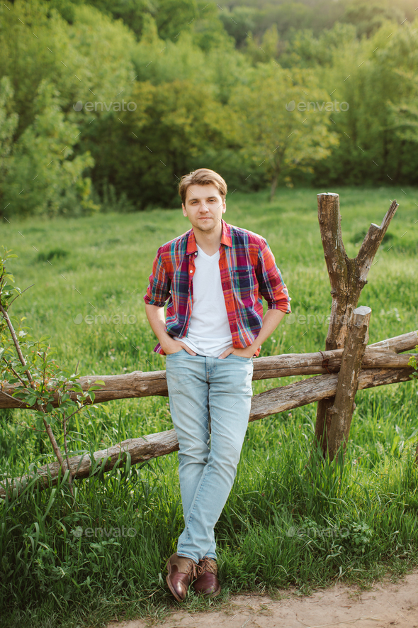Handsome Man against green nature background Stock Photo by artfotodima