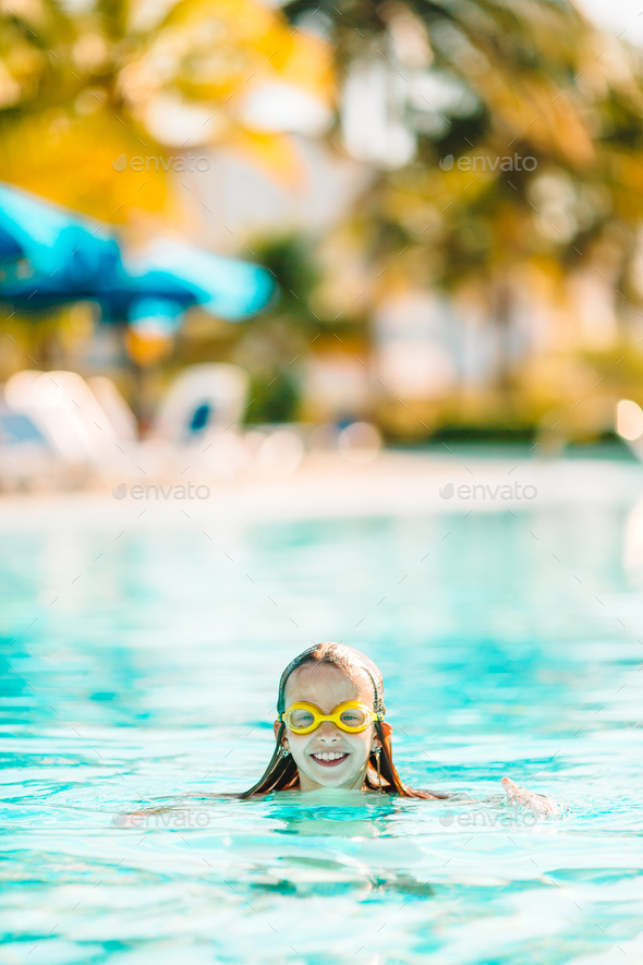Adorable little girl swimming at outdoor swimming pool Stock Photo by ...