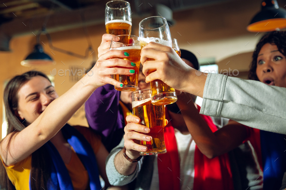 Sport fans cheering at bar, pub and drinking beer while championship ...