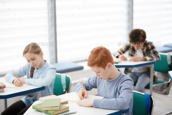Children Taking Test in School Stock Photo by seventyfourimages | PhotoDune