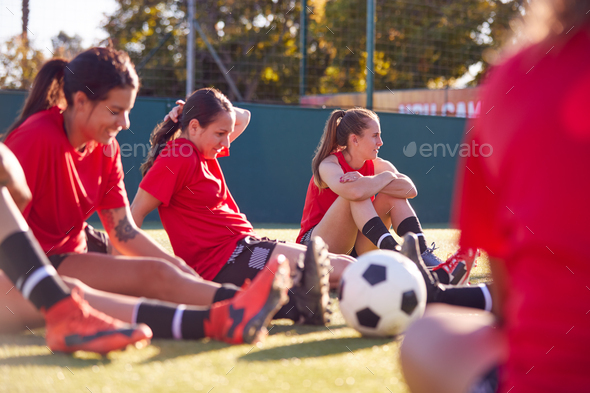 Womens Football Team Stretching Whilst Training For Soccer Match On ...