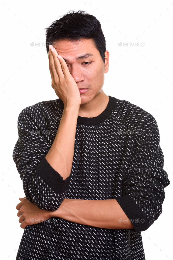 Studio shot of young Asian man looking tired Stock Photo by amazingmikael