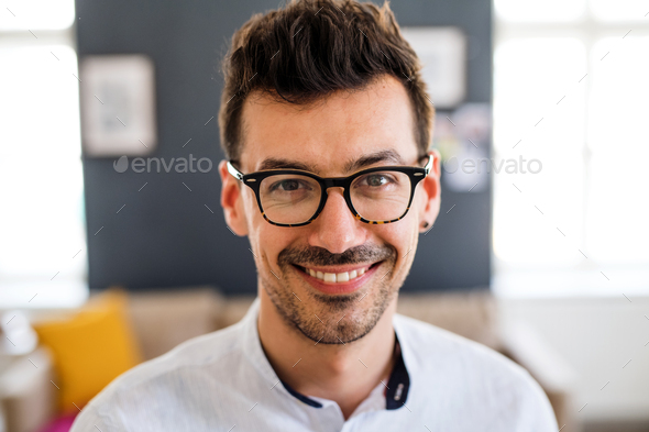 A portrait of young man indoors, a close-up Stock Photo by halfpoint