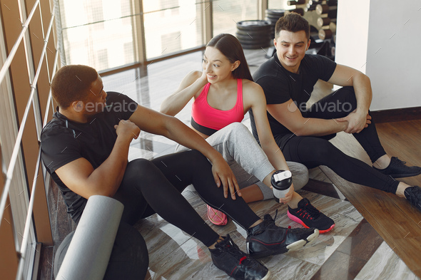 Young sports people training in a morning gym Stock Photo by prostooleh