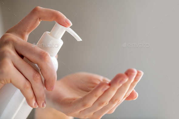 Girl applying soap disinfectant product on hand Stock Photo by byrdyak