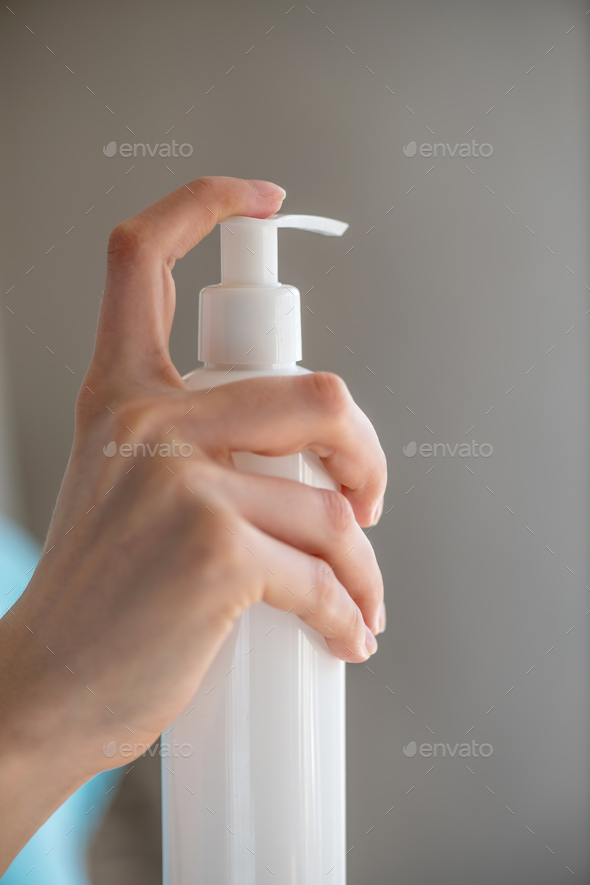Girl applying soap disinfectant product on hand Stock Photo by byrdyak