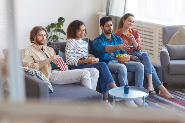 Multi Ethnic Group of People Watching TV at Home Stock Photo by ...