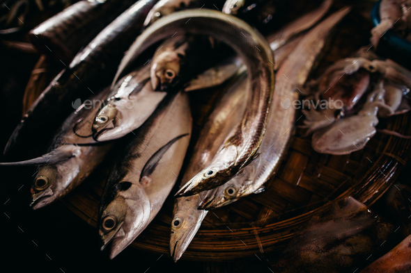 Raw fish sliced and cut at street market Stock Photo by avanti_photo