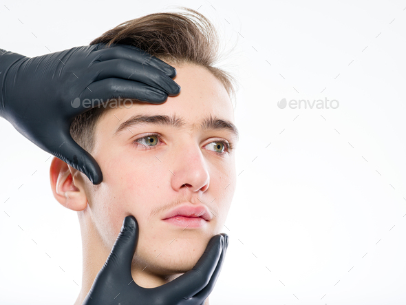 Face skin check. Beautician touching male face. Stock Photo by valuavitaly