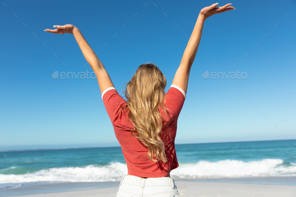 Rear view young woman at the beach Stock Photo by Wavebreakmedia ...