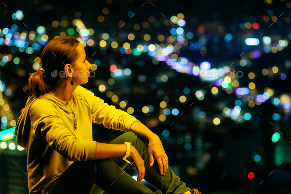 woman relaxing on rooftop of the building with night view Stock Photo ...