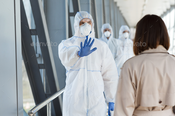 Medical worker showing stop sign to woman Stock Photo by Prostock-studio