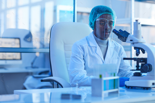 Man working with microscope at the lab Stock Photo by AnnaStills ...