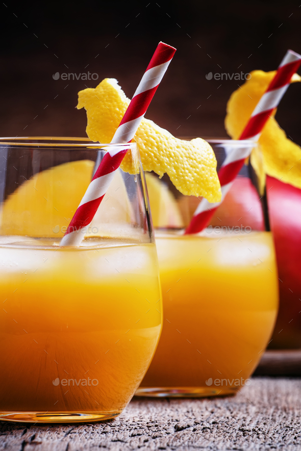 Freshly squeezed mango juice with ice and straws Stock Photo by 5PH