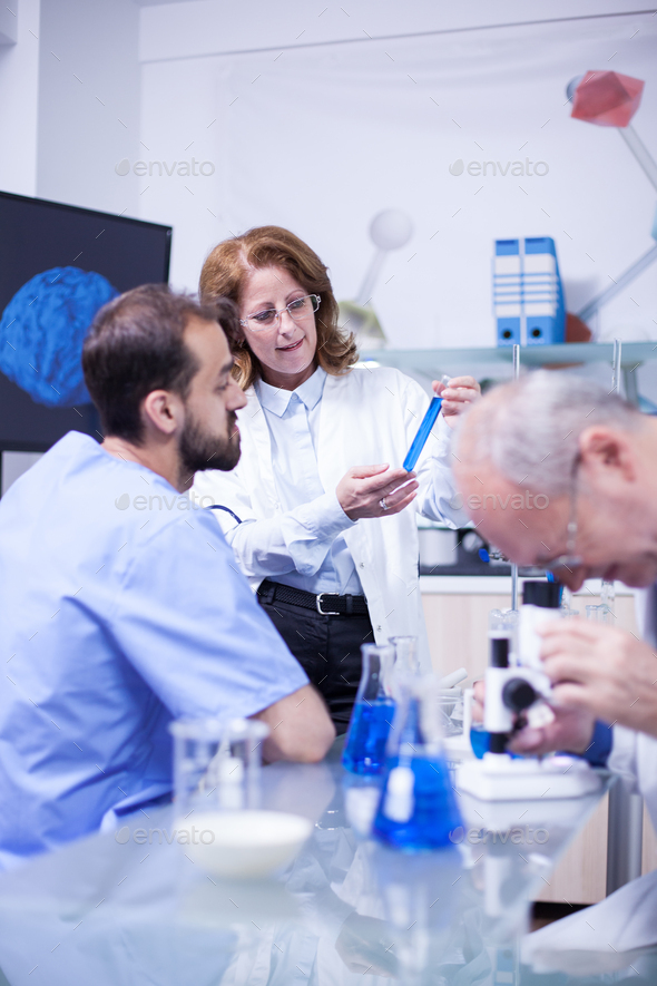 Medical professor working with microscope in the hospital laboratory ...