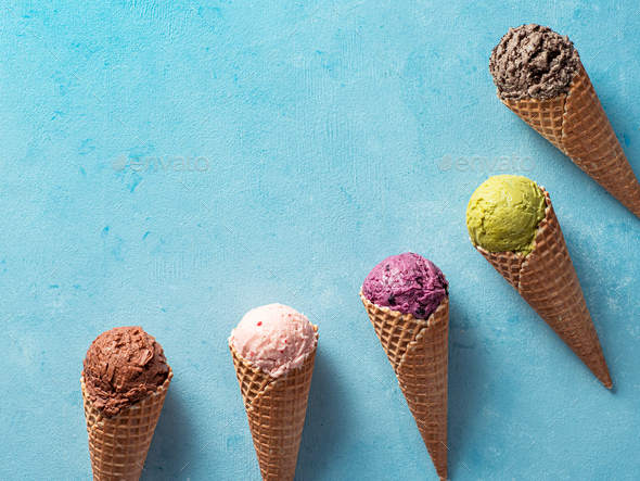 ice cream scoops in cones with copy space on blue Stock Photo by Fasci