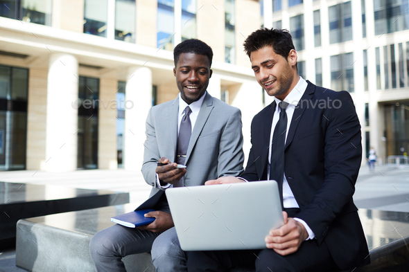 Business people with laptop outdoors Stock Photo by AnnaStills | PhotoDune