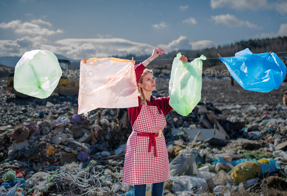 Woman on landfill, consumerism versus plastic pollution concept Stock ...