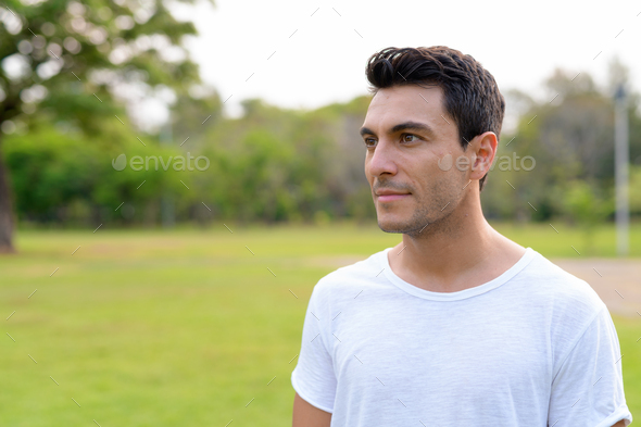 Face of young handsome Hispanic man thinking at the park Stock Photo by ...
