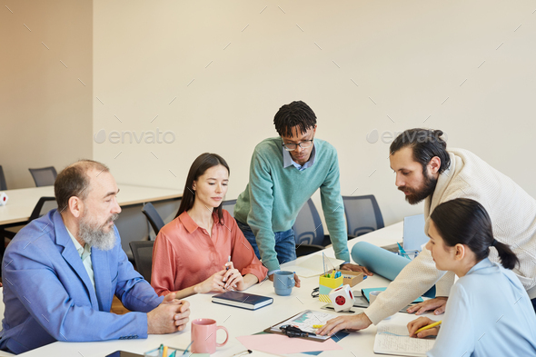 Five Business People Working Together Stock Photo by seventyfourimages