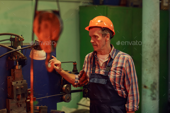 Manual worker working at machine Stock Photo by AnnaStills | PhotoDune