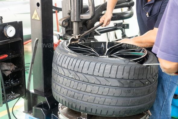Series of worker removing tire from rim with removal machinery Stock ...