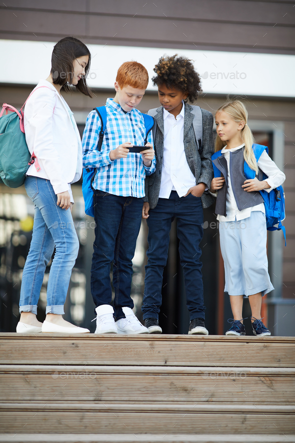 School children using mobile phone Stock Photo by AnnaStills | PhotoDune
