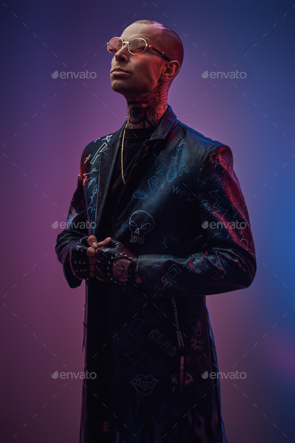 Elegant tattooed male model posing in a studio Stock Photo by fxquadro