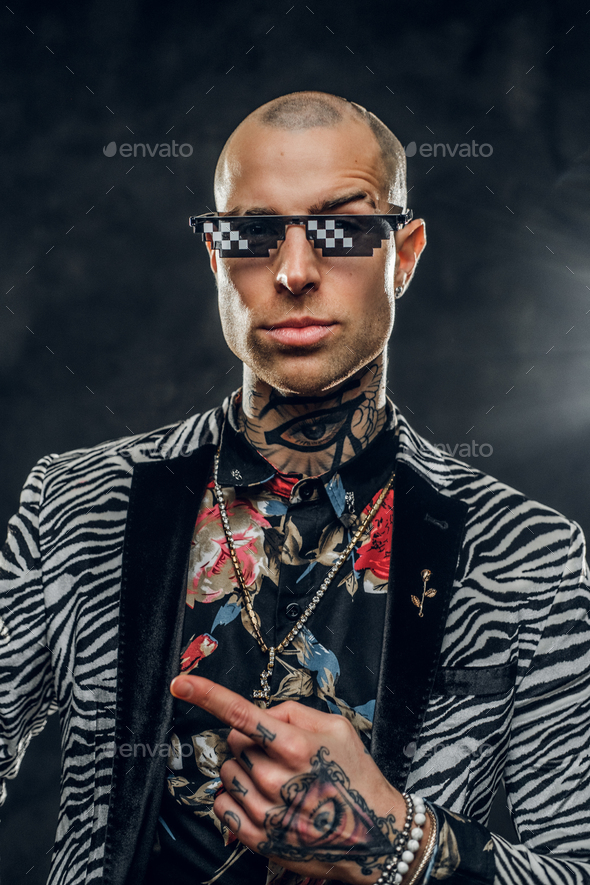 Fashionable tattooed male model posing in a studio Stock Photo by fxquadro