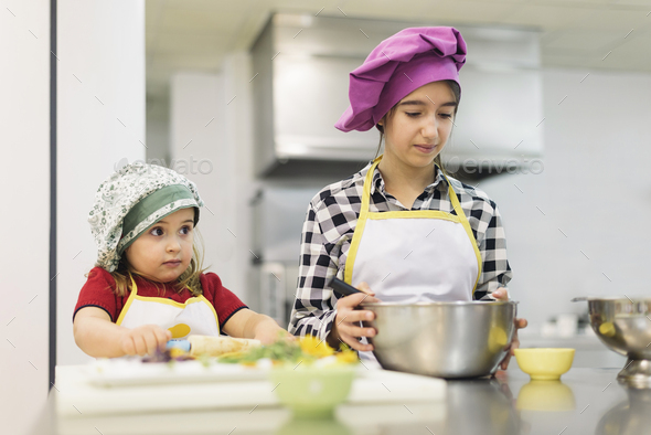 Happy girl cooking in a kitchen. Stock Photo by nunezimage | PhotoDune