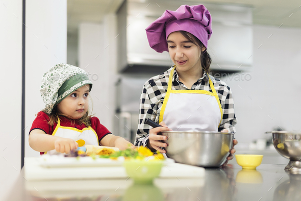 Happy girl cooking in a kitchen. Stock Photo by nunezimage | PhotoDune