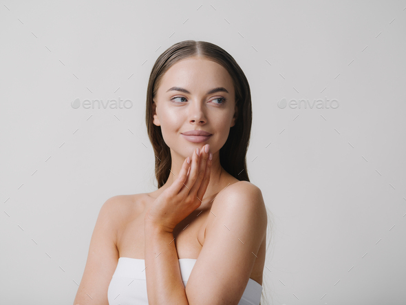 Natural beauty woman with heands touching face long brunette hair ...