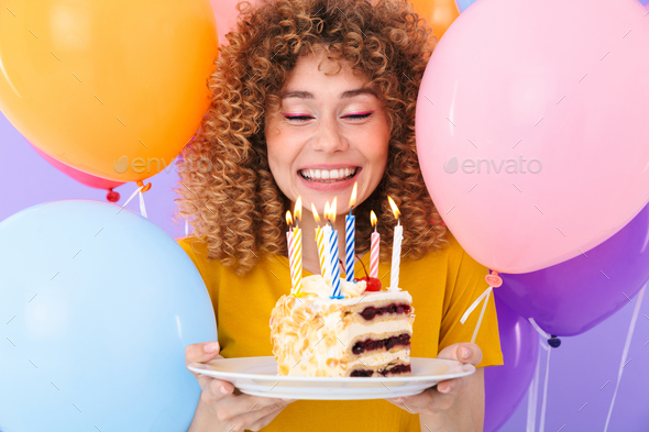 Image of delighted young woman celebrating birthday with multicolored ...