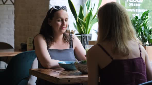 Two Young Women Having Lunch Break at Cafe, Stock Footage | VideoHive
