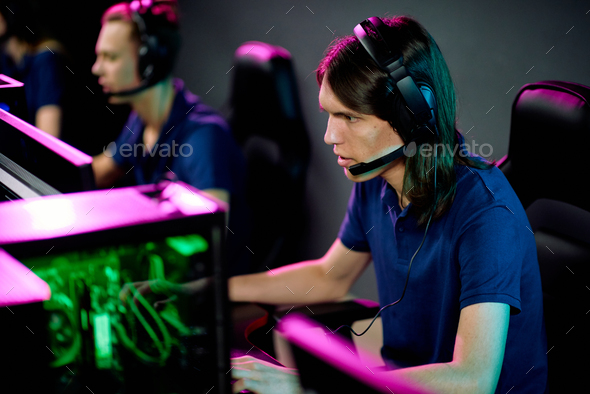 Row of operators with headsets sitting in armchairs in front of ...